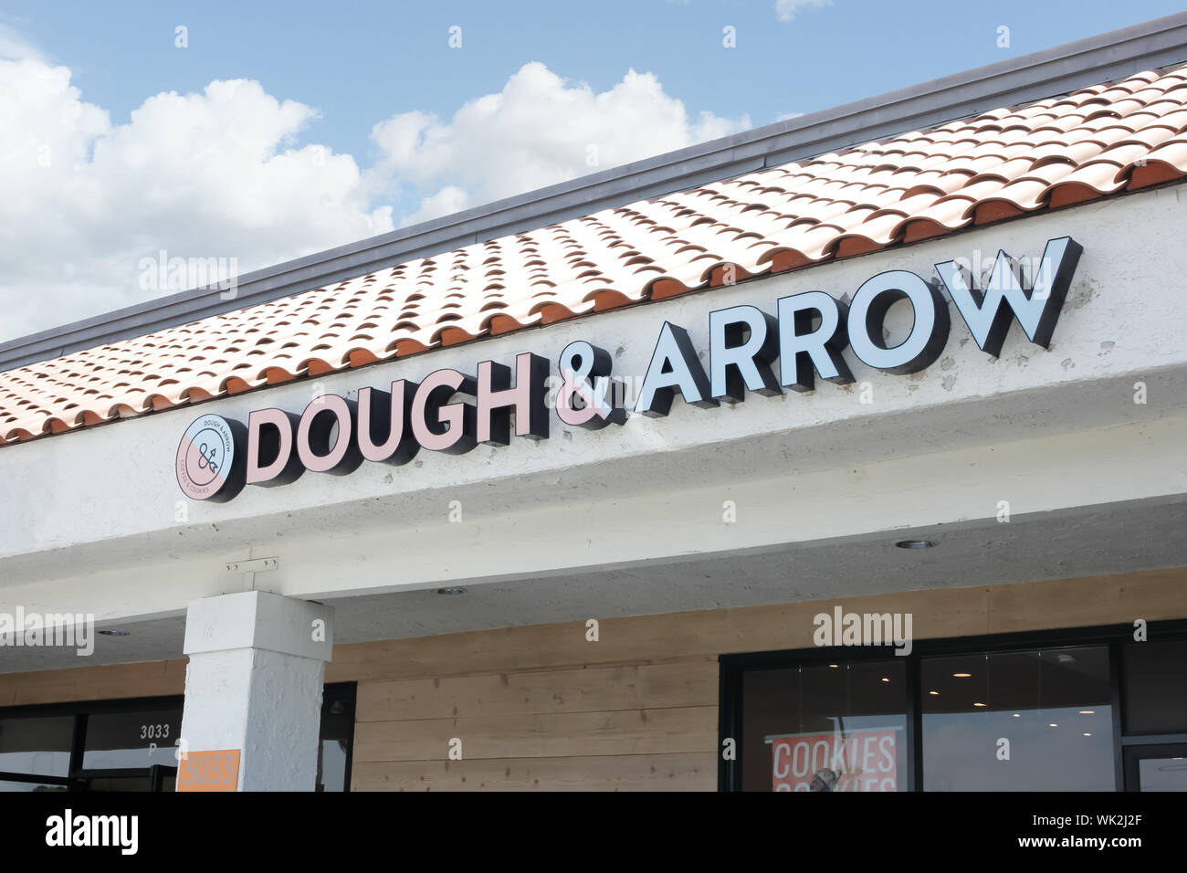 A store front sign for the dessert shop known as Dough & Arrow Stock ...