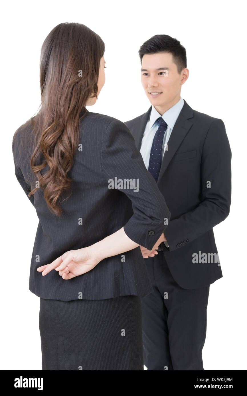Business woman and man shake hands and put finger cross on back ...