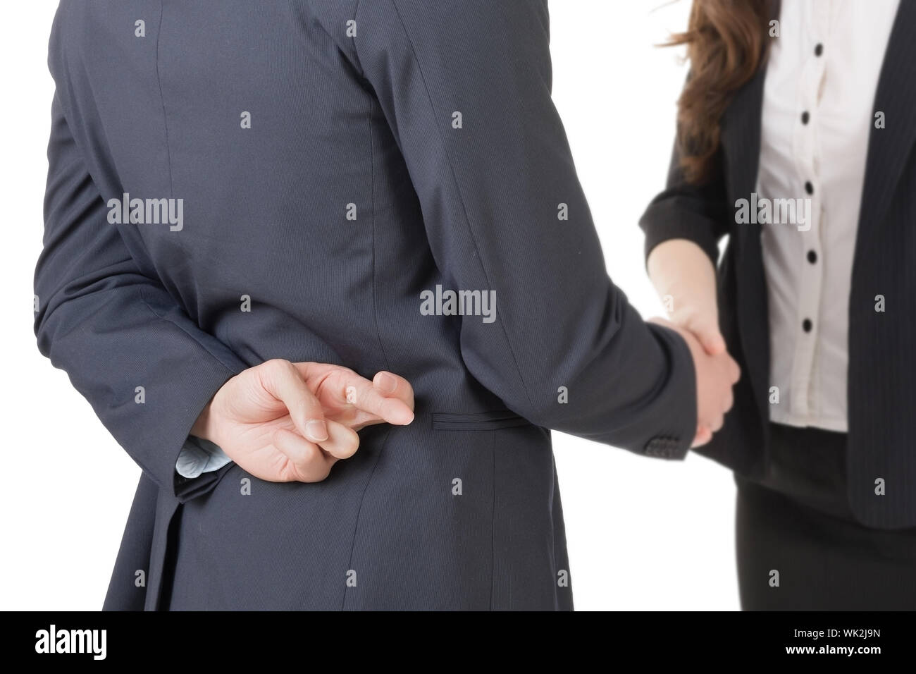 Business woman and man shake hands and put finger cross on back ...