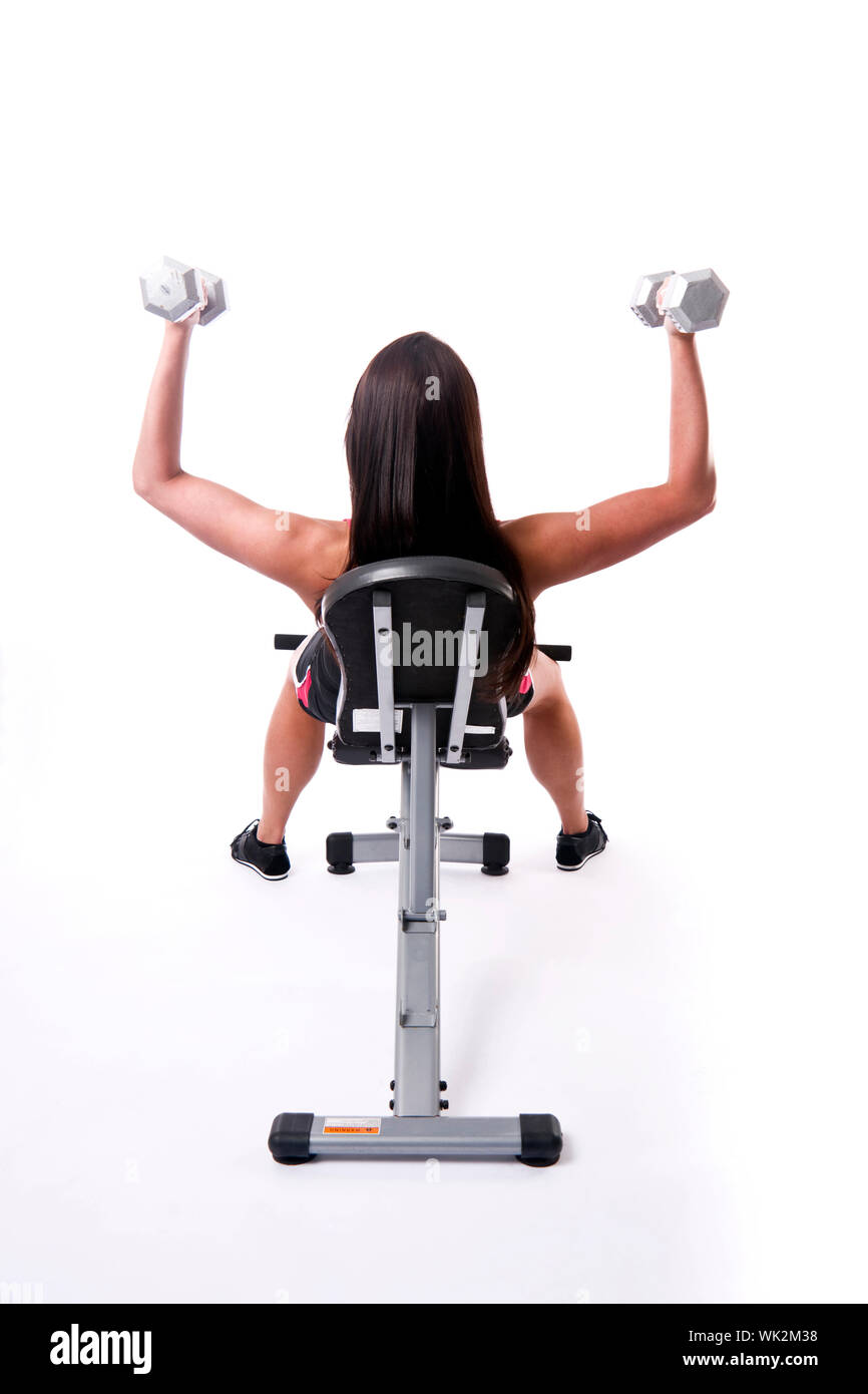 Beautiful young woman lifts hand weights Stock Photo - Alamy