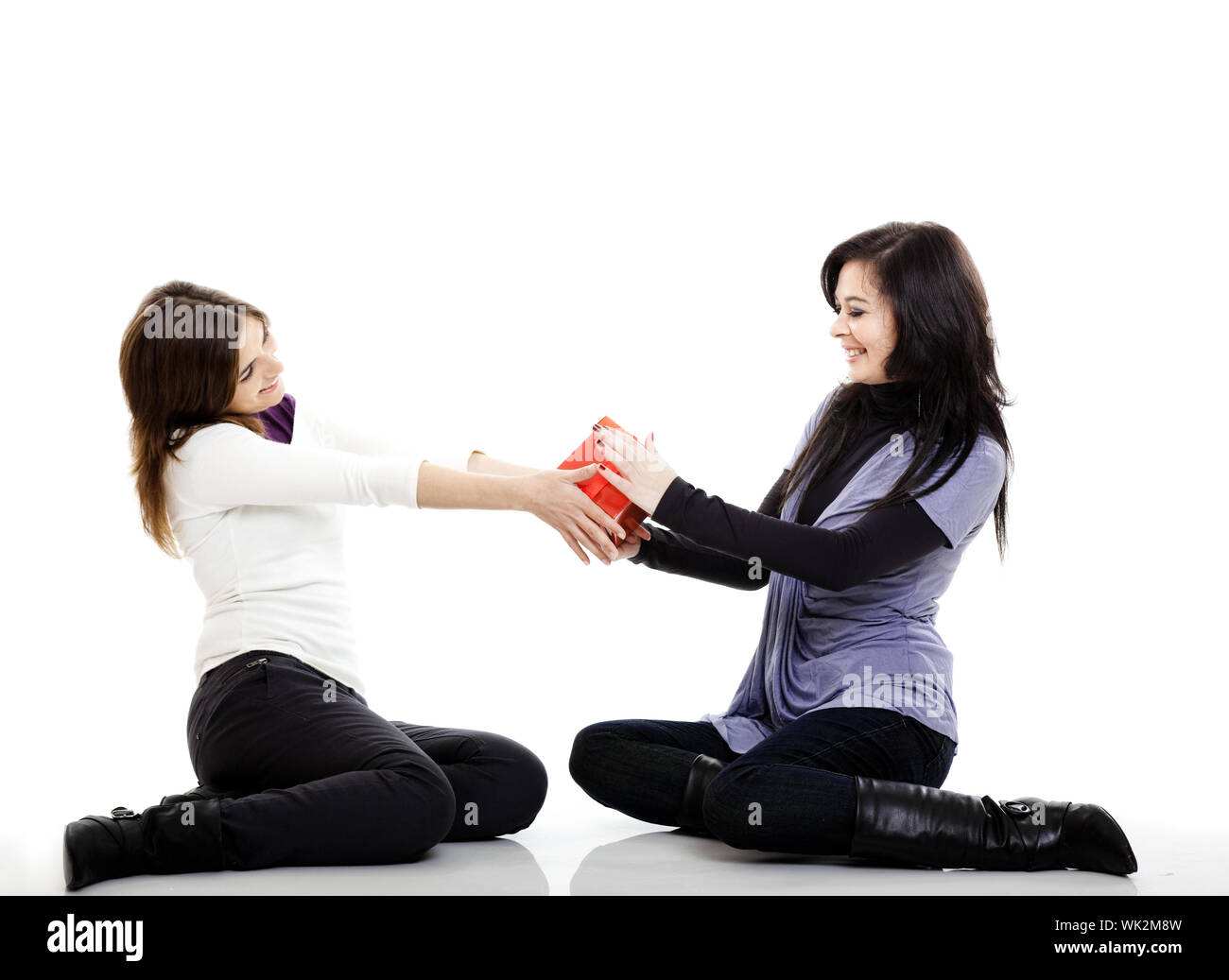 Beautiful young woman giving and receive a gift Stock Photo - Alamy