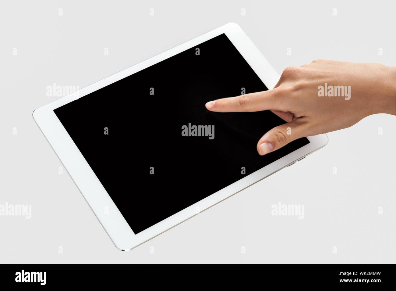 Finger pointing on tablet screen Stock Photo - Alamy