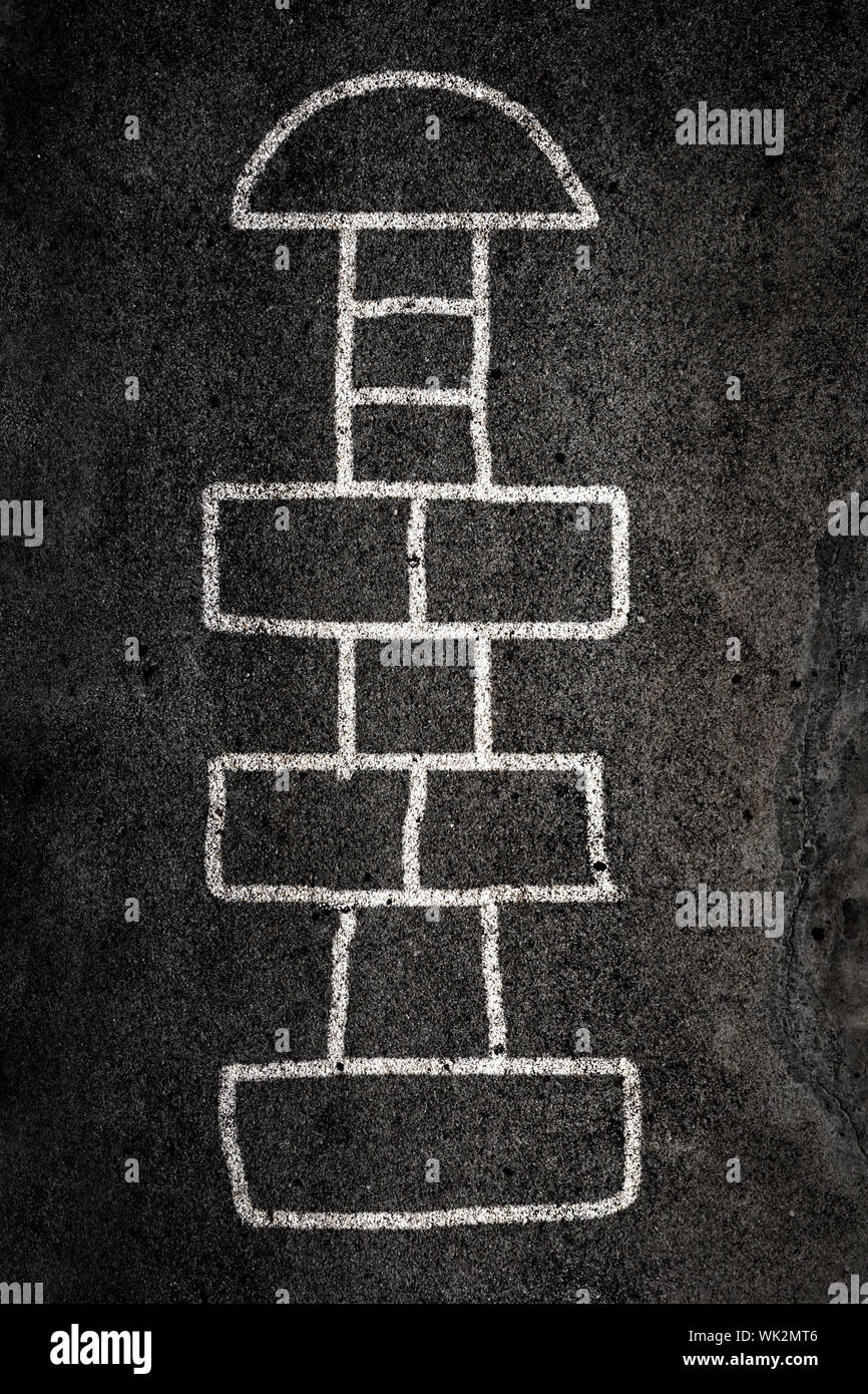 Hopscotch game designed on the road with chalk Stock Photo - Alamy