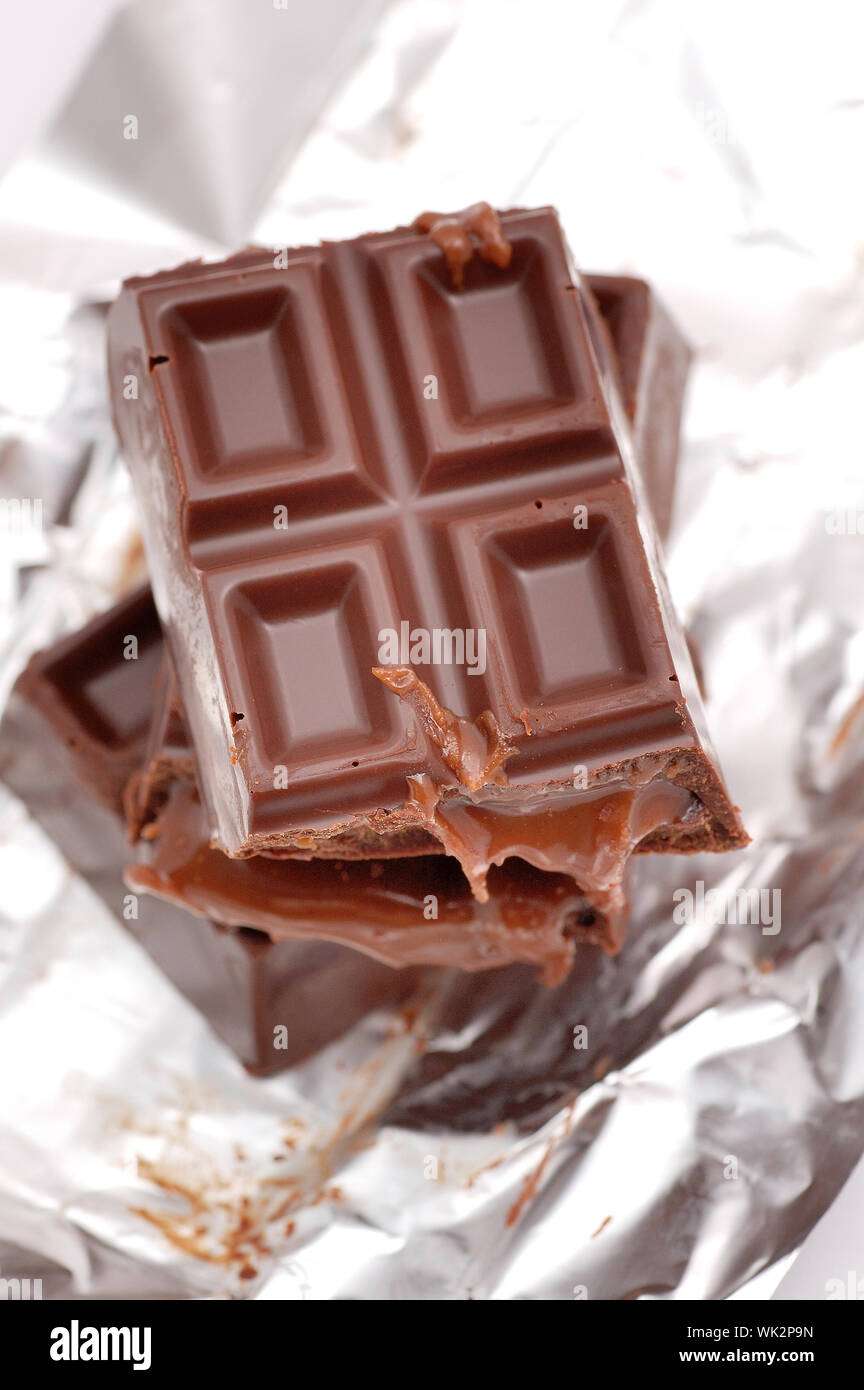 Broken chocolate on the foil Stock Photo - Alamy