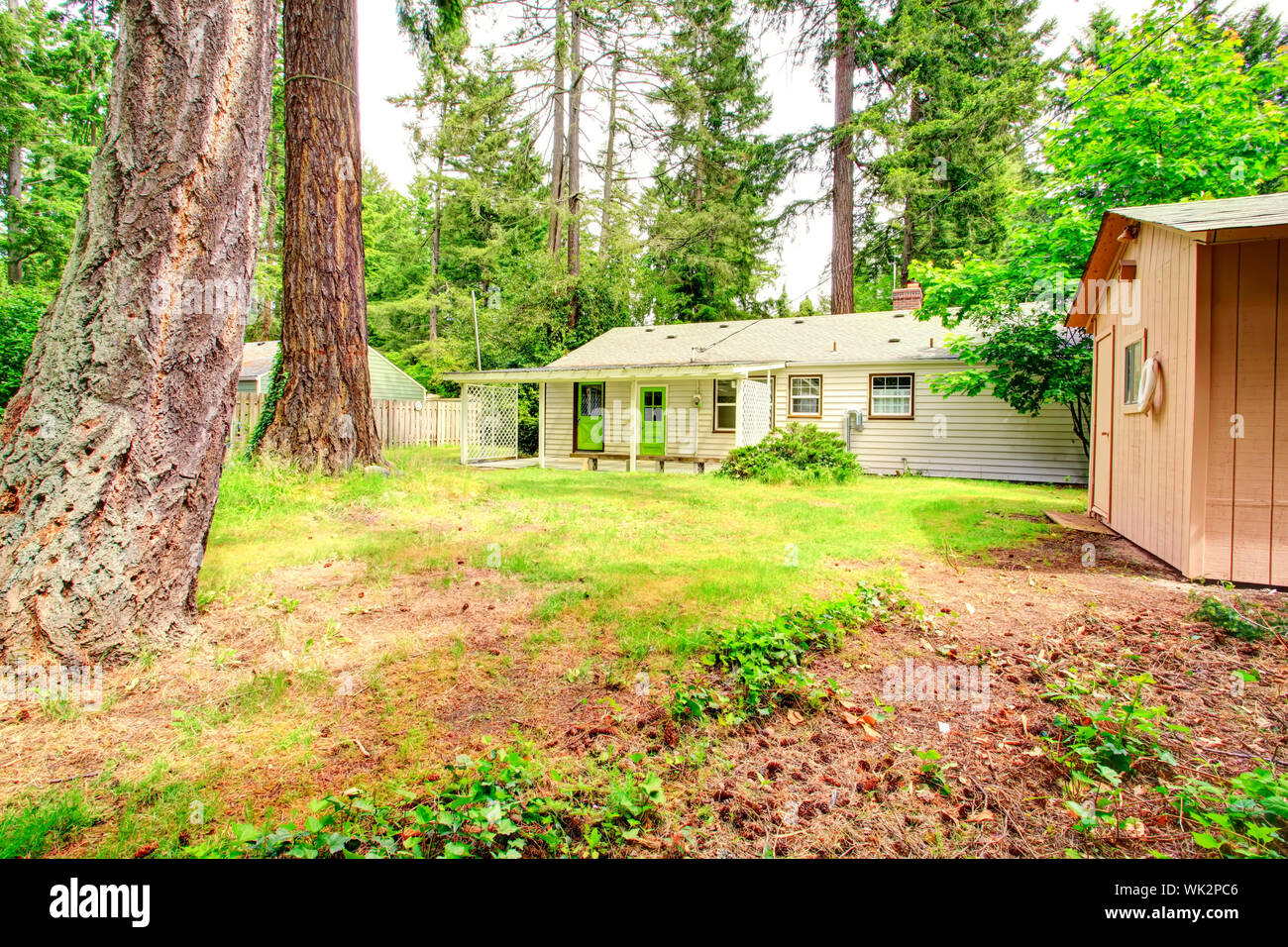 Countryside house with backyard. View of covered porch and shed Stock ...