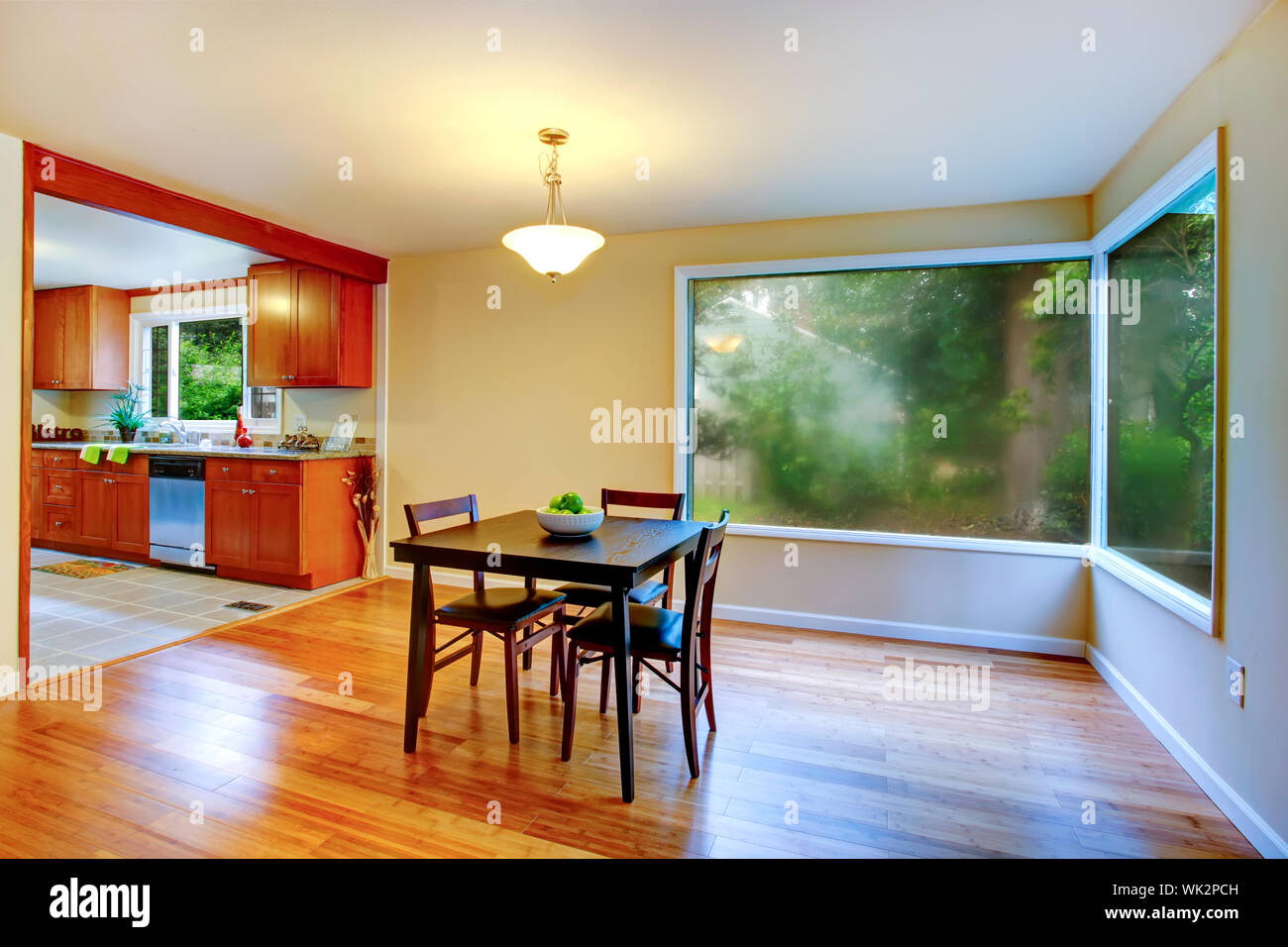 View of dining area with hardwood floor and uncurtained window Stock ...