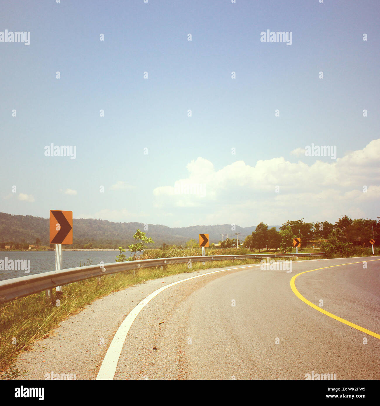 Curve road sign with retro filter effect Stock Photo - Alamy
