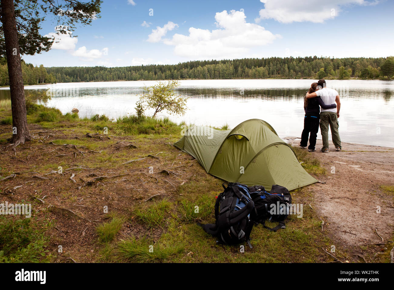 A summer camping lifestyle shot with a forest and lake landscape Stock ...