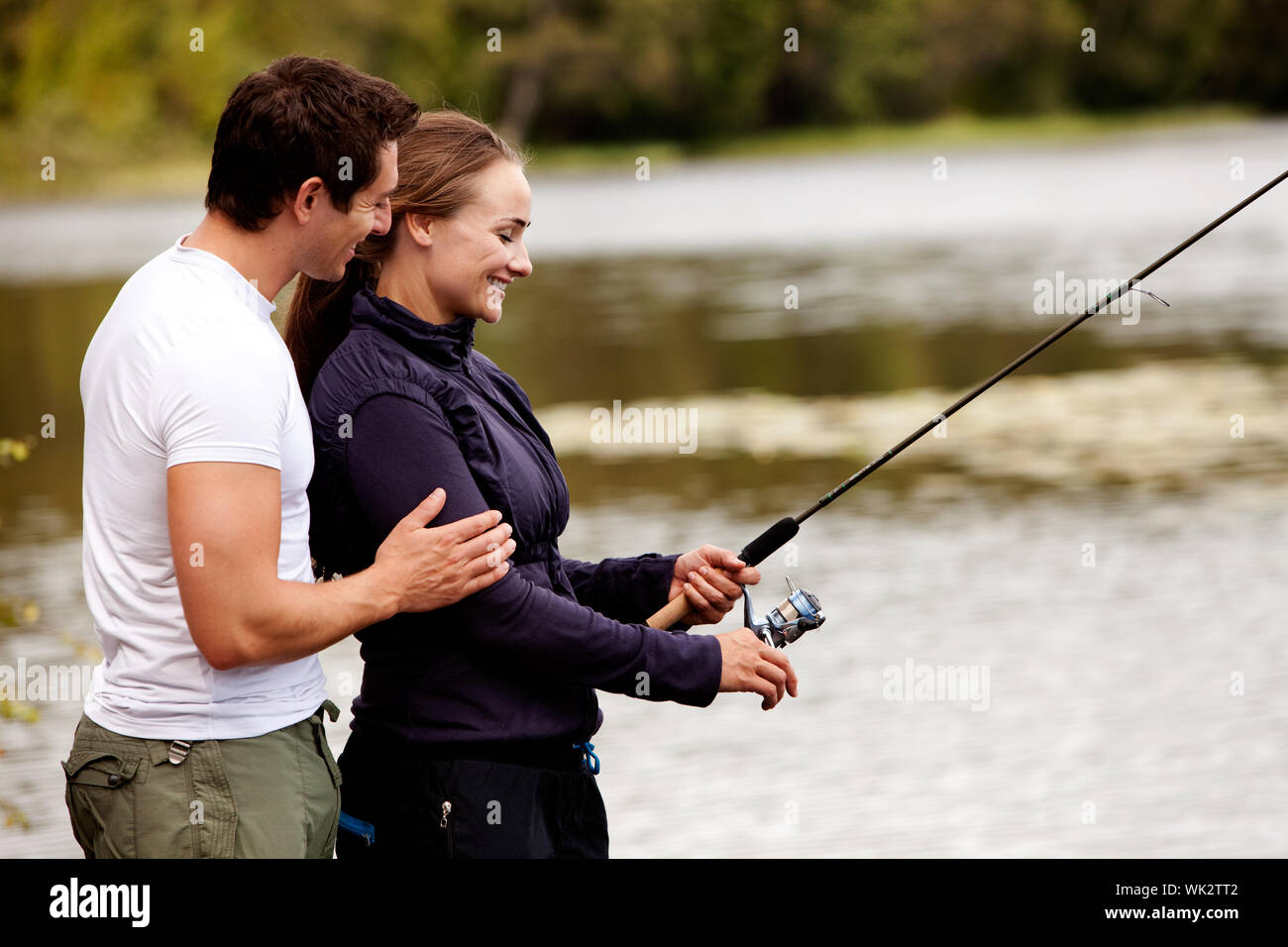 Happy Fishing Woman Stock Photo - Alamy