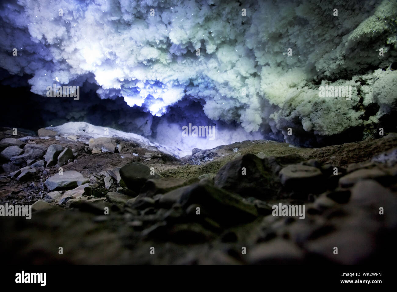 A dark and mysterious snow ice cave - A glacial grotto Stock Photo - Alamy