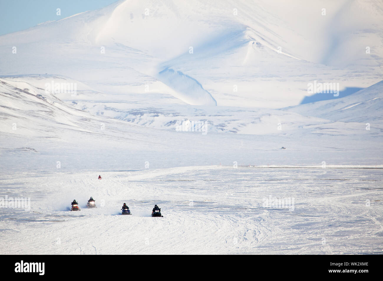 A group of snowmobiles on the ice outside Longyearbyen, Svalbard Norway ...