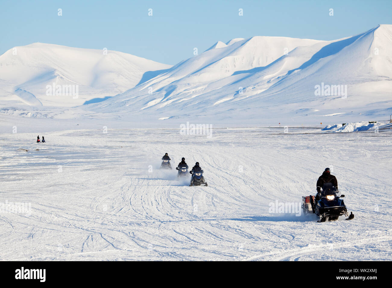 A group of snowmobiles on the ice outside Longyearbyen, Svalbard Norway ...