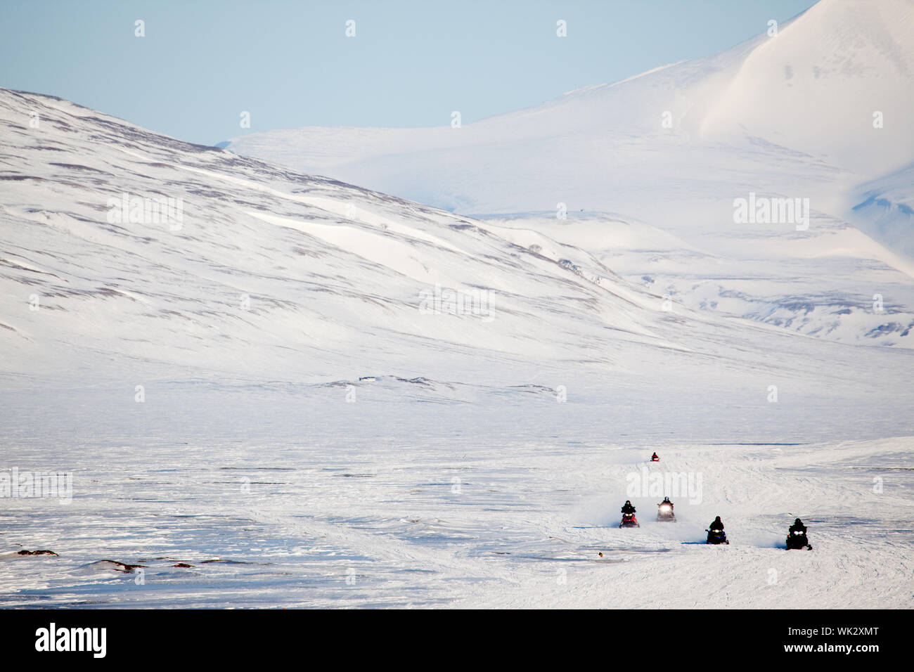A group of snowmobiles on the ice outside Longyearbyen, Svalbard Norway ...