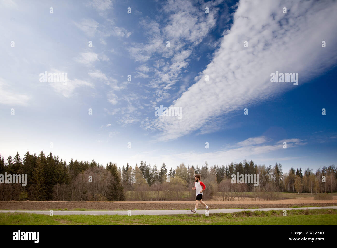 A runner with long hair and beard jogging in the country Stock Photo ...