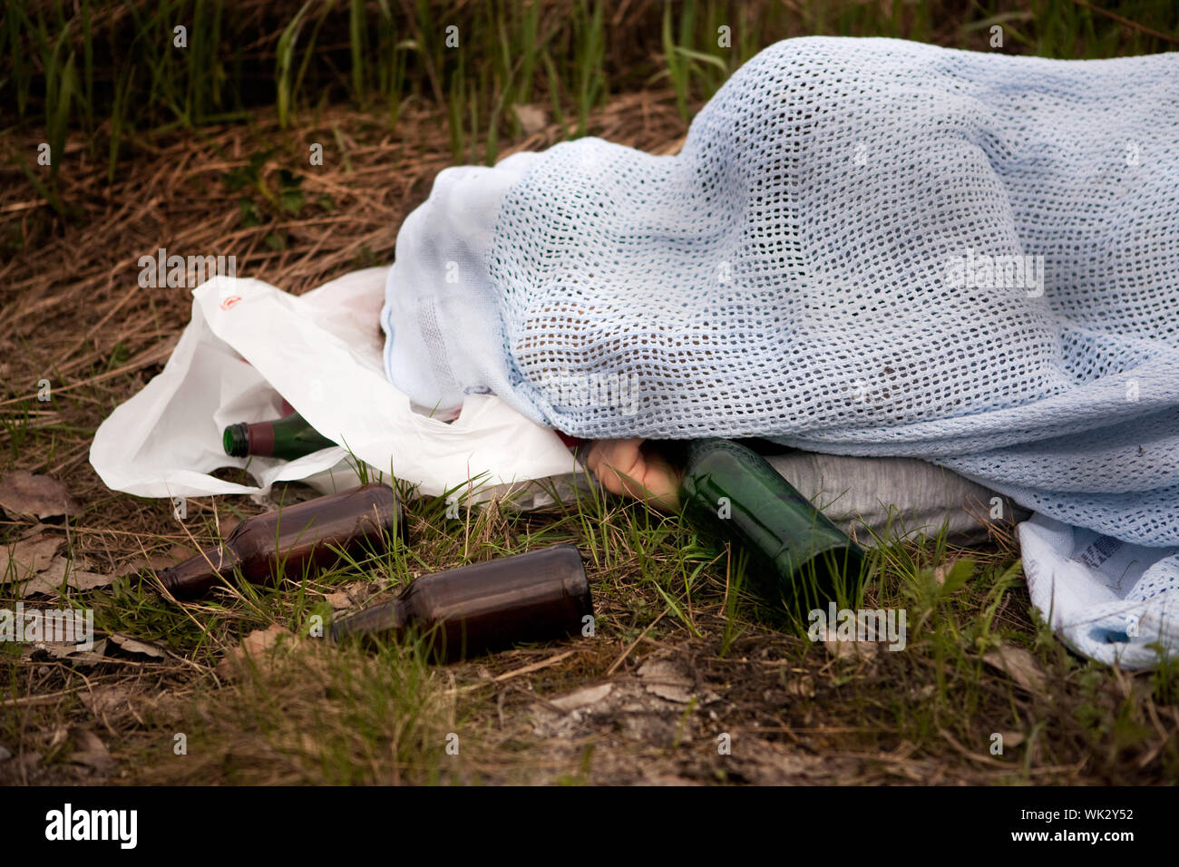 A homeless man with a number of beer bottles Stock Photo - Alamy