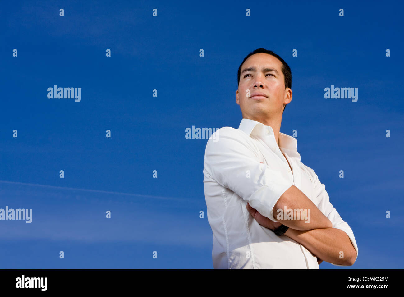 Smart handsome asian man looking forward in a positive and brave manner ...