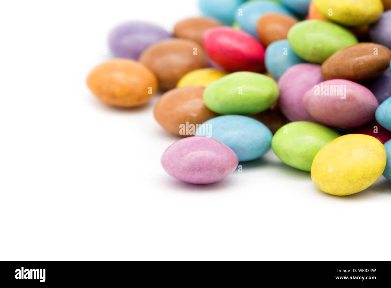 sweet dragees of different color on white background Stock Photo - Alamy