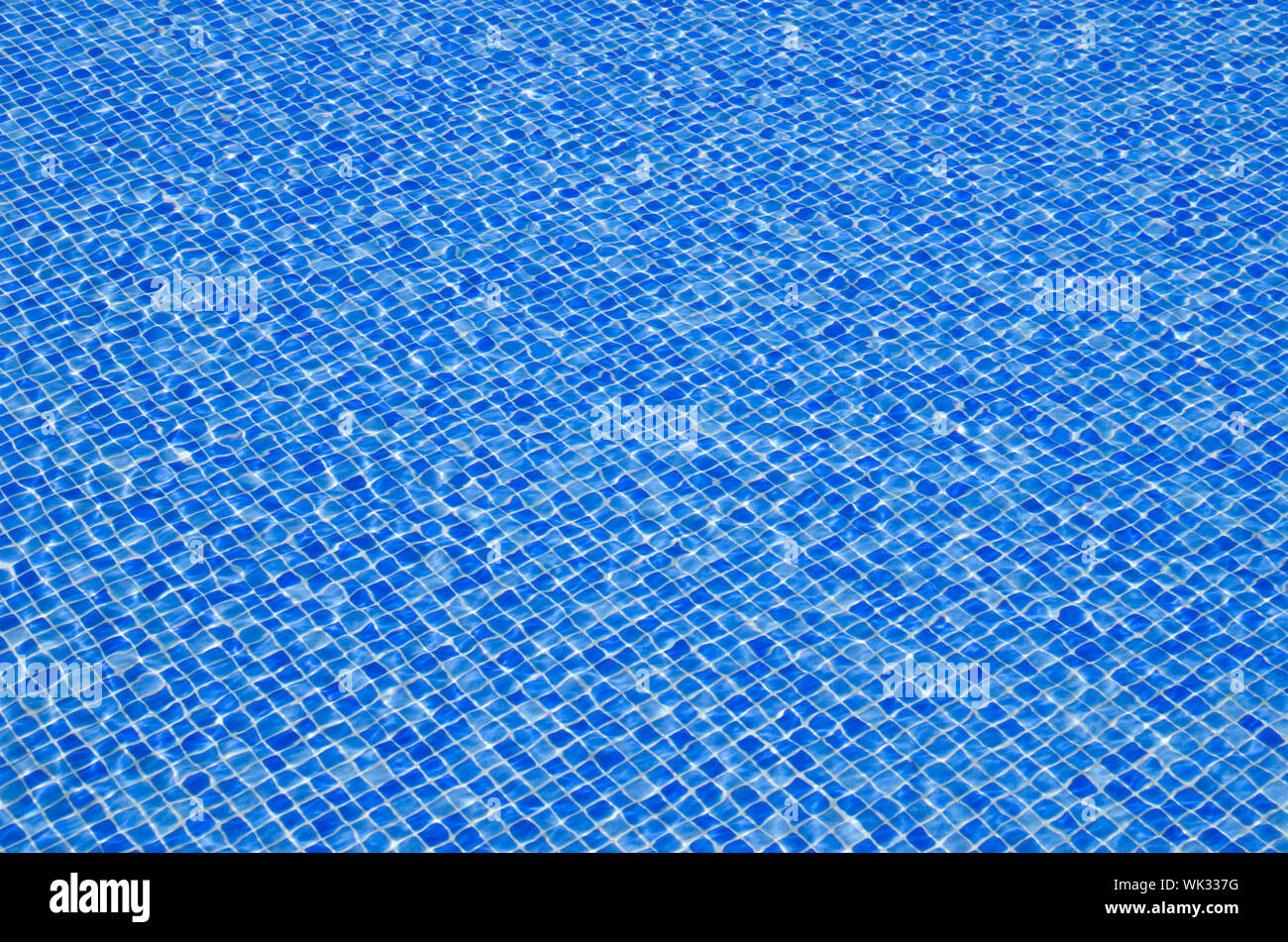 Blue pool water with sun reflections Stock Photo - Alamy