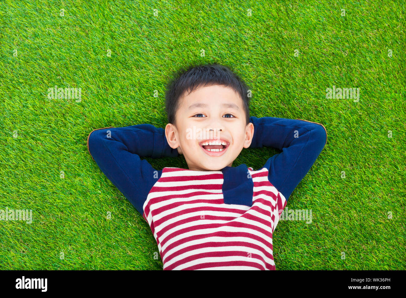 Happy kid lying thumb up hi-res stock photography and images - Alamy