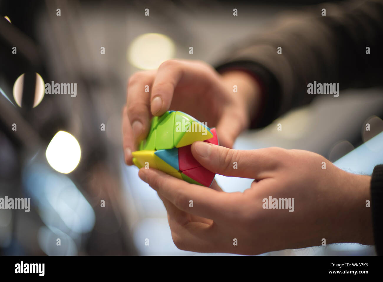 man collects the cube rubik. Intellectual puzzle Stock Photo - Alamy