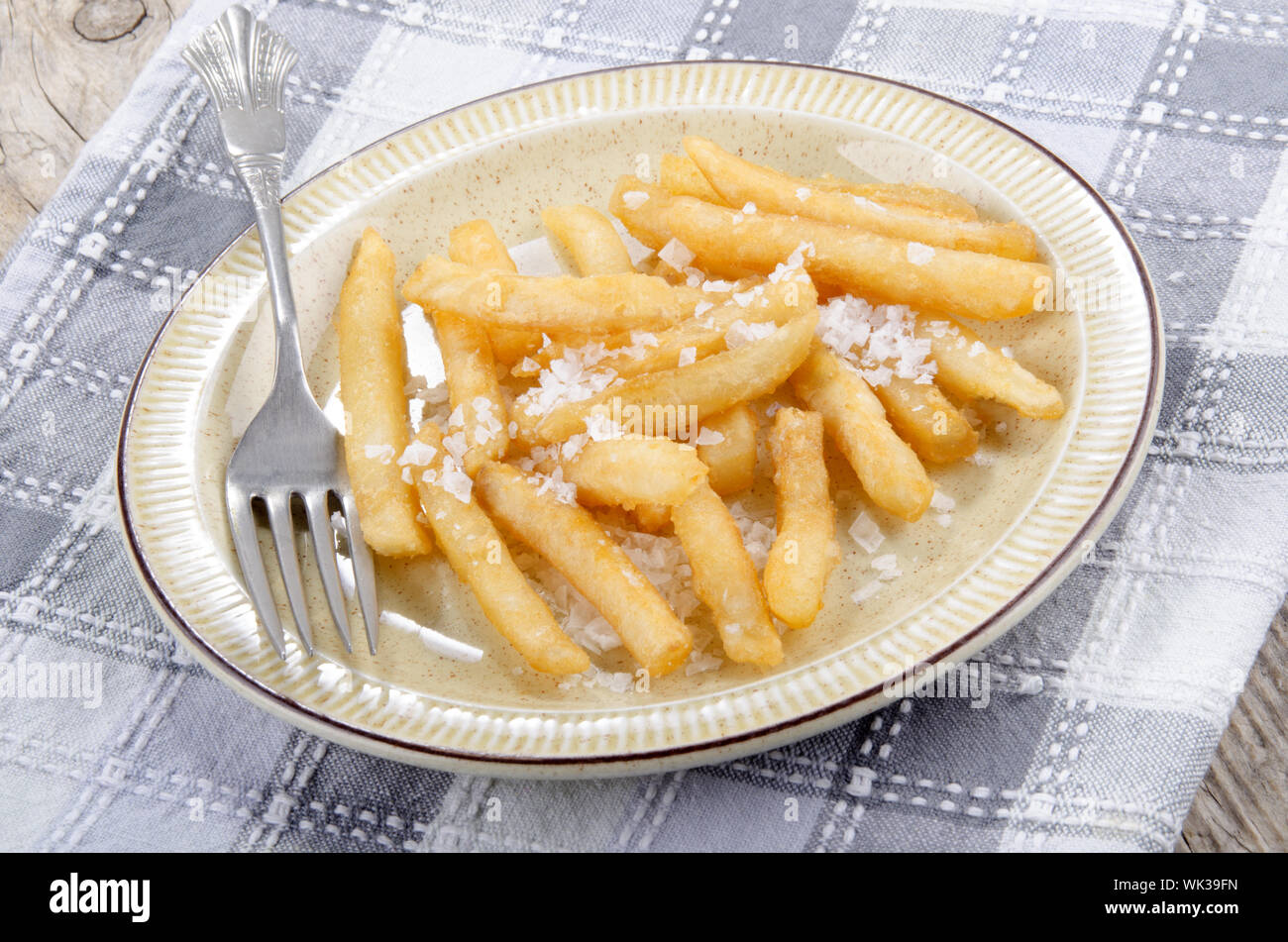 french fries with salt and fork on a plate Stock Photo - Alamy
