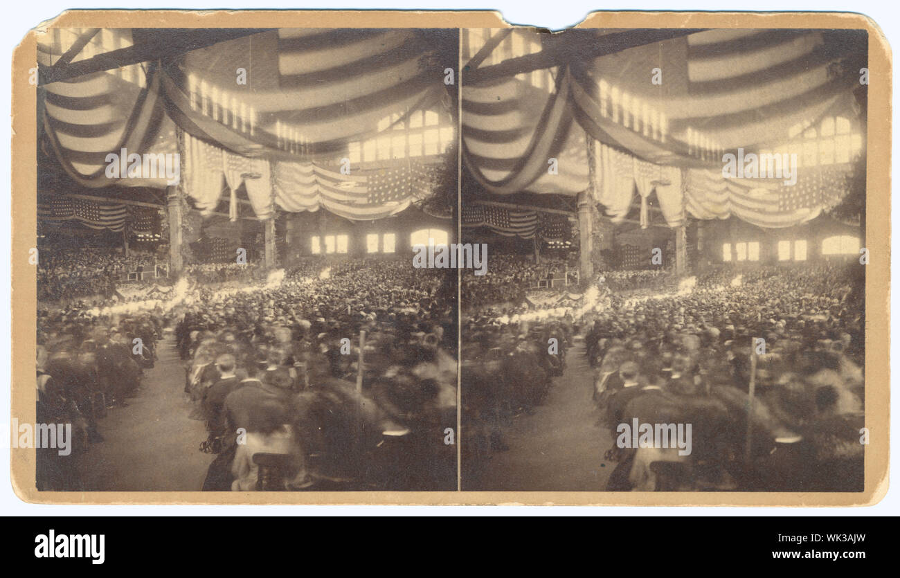 Interior view of a large convention hall filled with people sitting in ...
