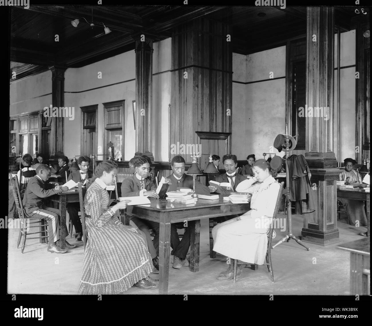 Interior view of library reading room with male and female students ...