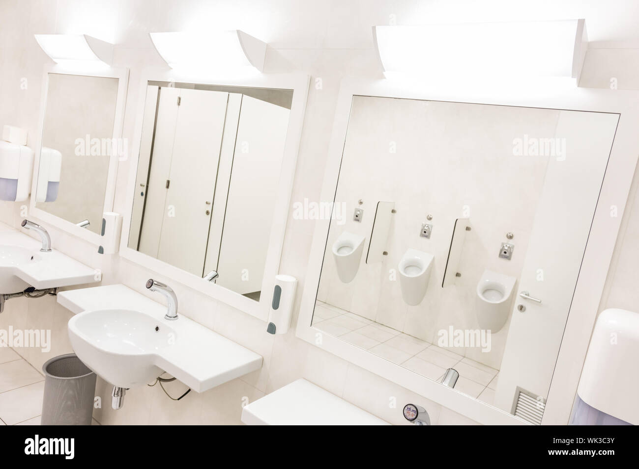 Public empty white man restroom with washstands mirrors Stock Photo - Alamy