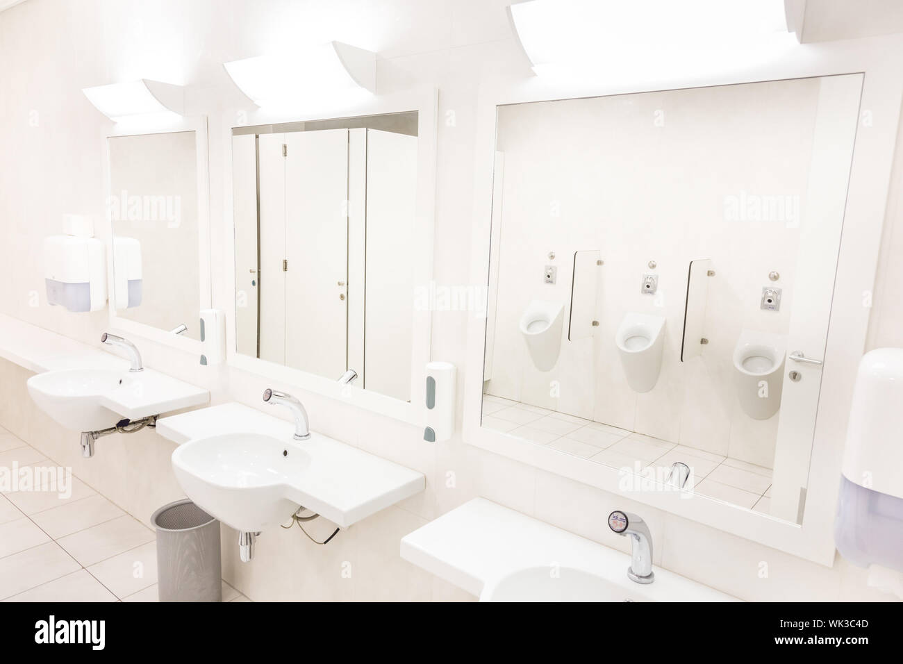 Public empty white man restroom with washstands mirrors Stock Photo - Alamy