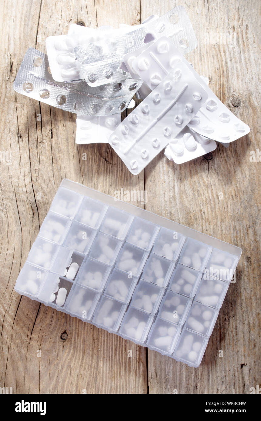 filled pill dispenser and emptied pills packing Stock Photo - Alamy