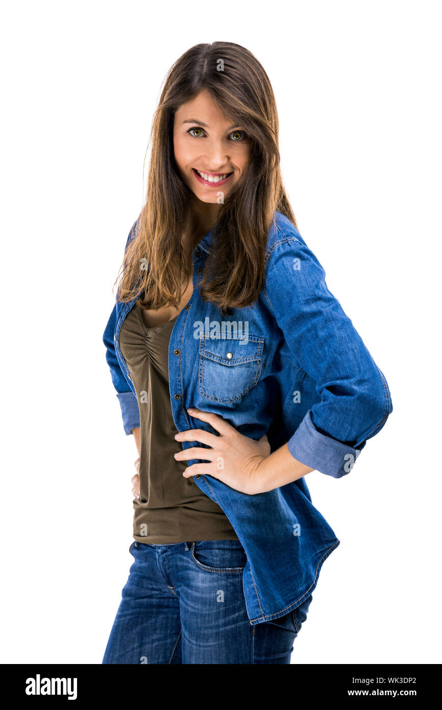 Beautiful woman standing over a white background with hands on the hips ...