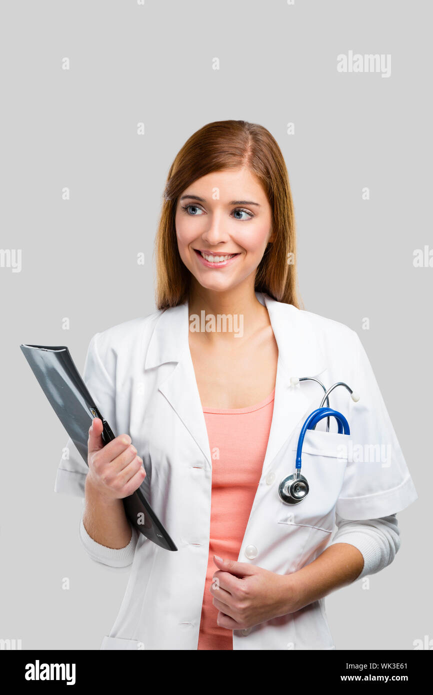 Beautiful and attractive female doctor, isolated over a white ...