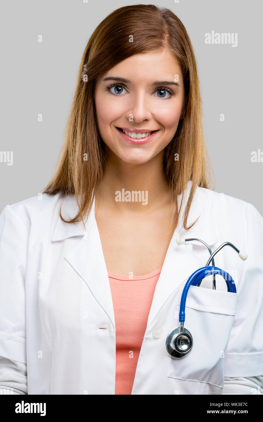 Beautiful and attractive female doctor, isolated over a white ...