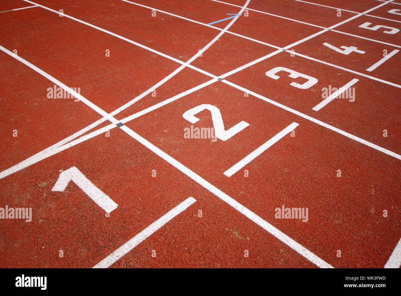 numbers of a racetrack, on red tarmac, for runners Stock Photo - Alamy