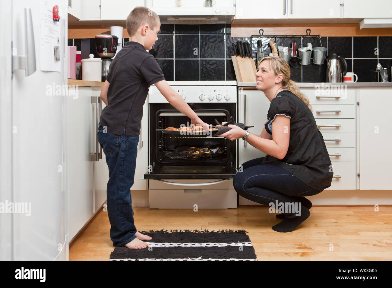 Mother and son in a kitchen situation Stock Photo - Alamy