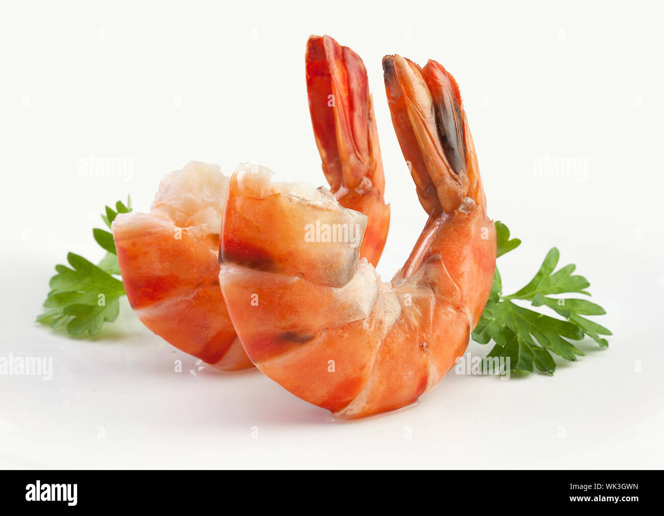 Two tiger shrimp's tails with fresh green parsley Stock Photo - Alamy