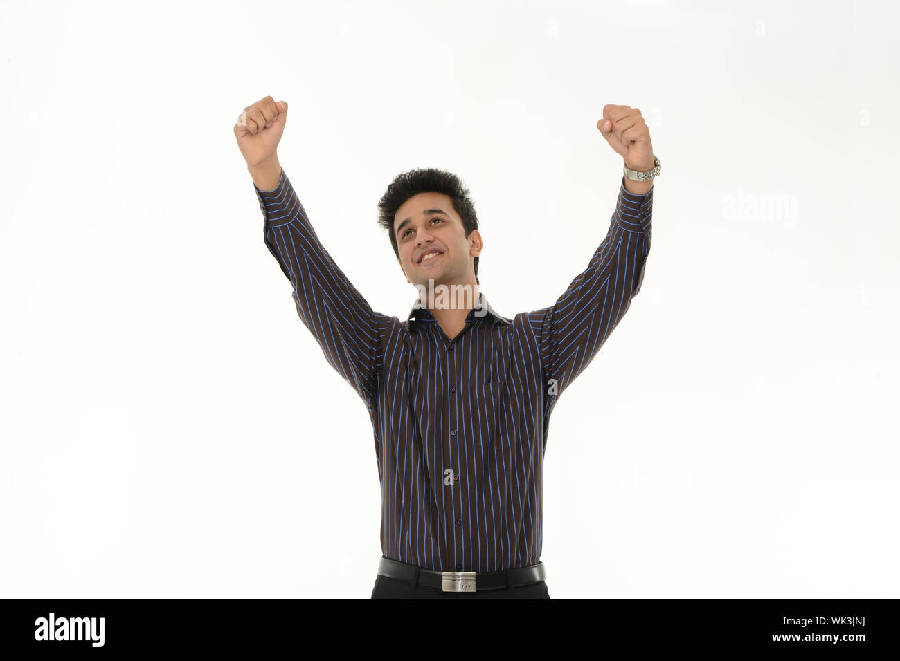 Indian young man celebrating his success and smiling Stock Photo - Alamy