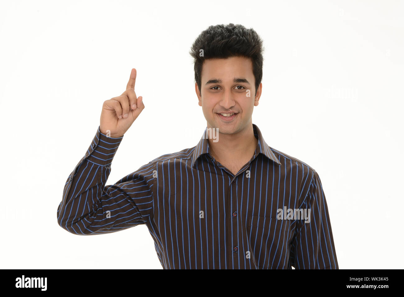 Young man showing pointing upward Stock Photo - Alamy