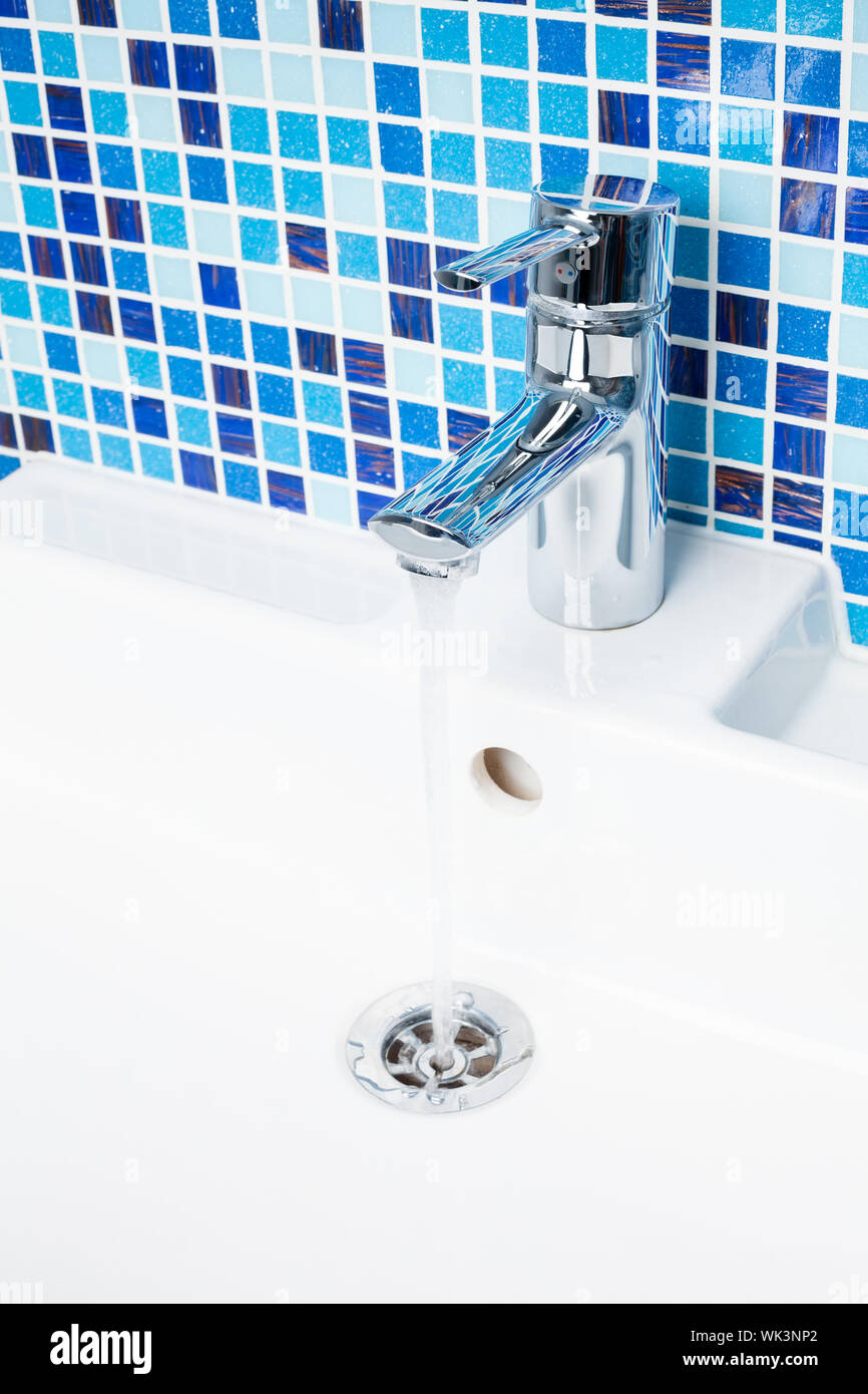 Single handle double-spout bathroom sink tap with running water Stock ...