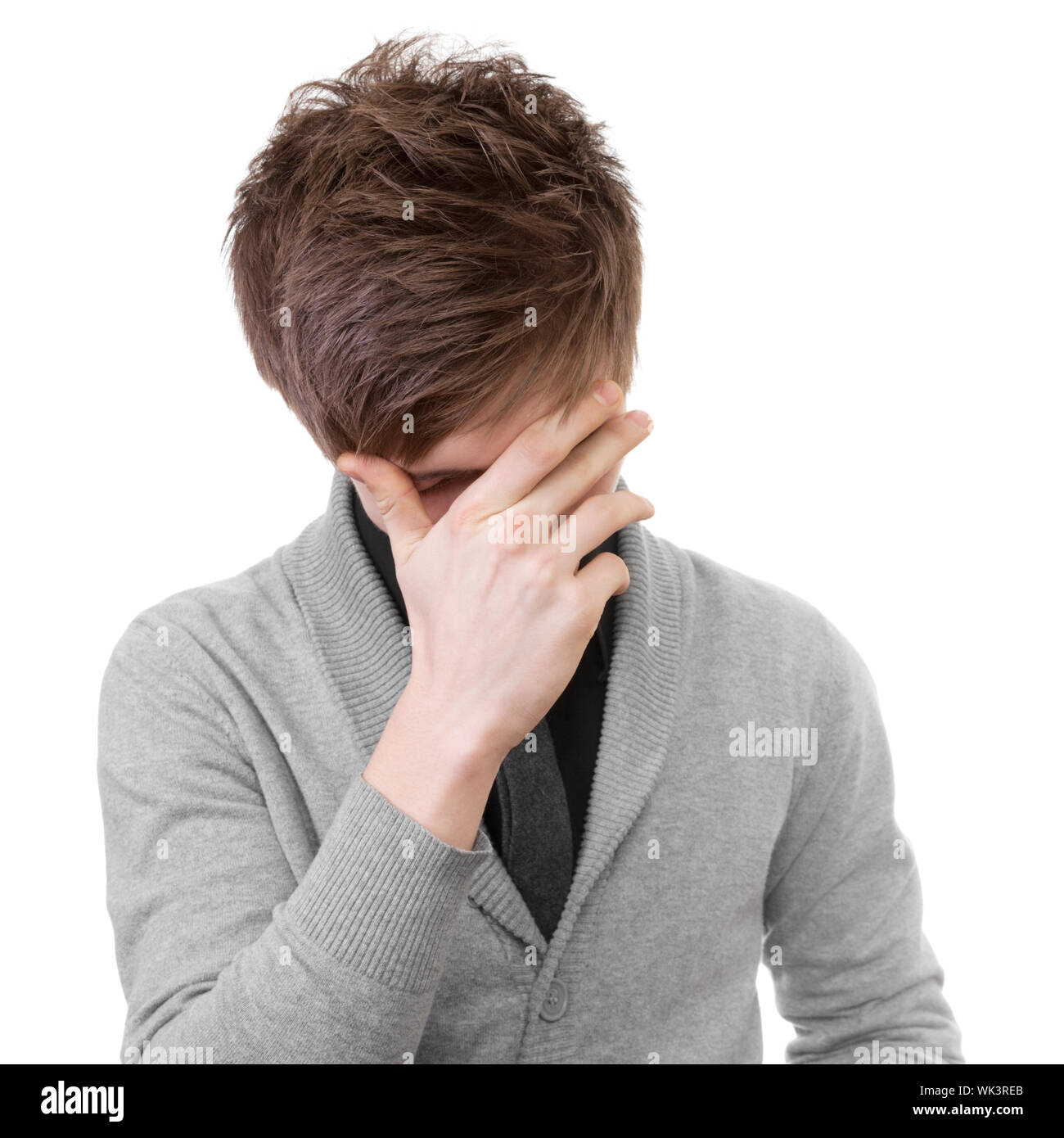 Sad young man covered his face with his hand. Isolation on white Stock ...
