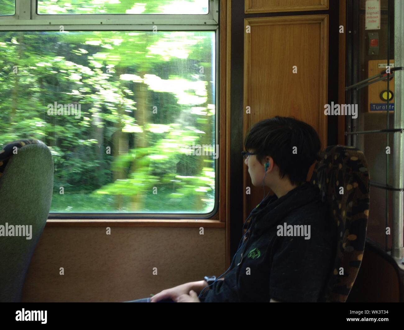 Person looking out train window hi-res stock photography and images - Alamy