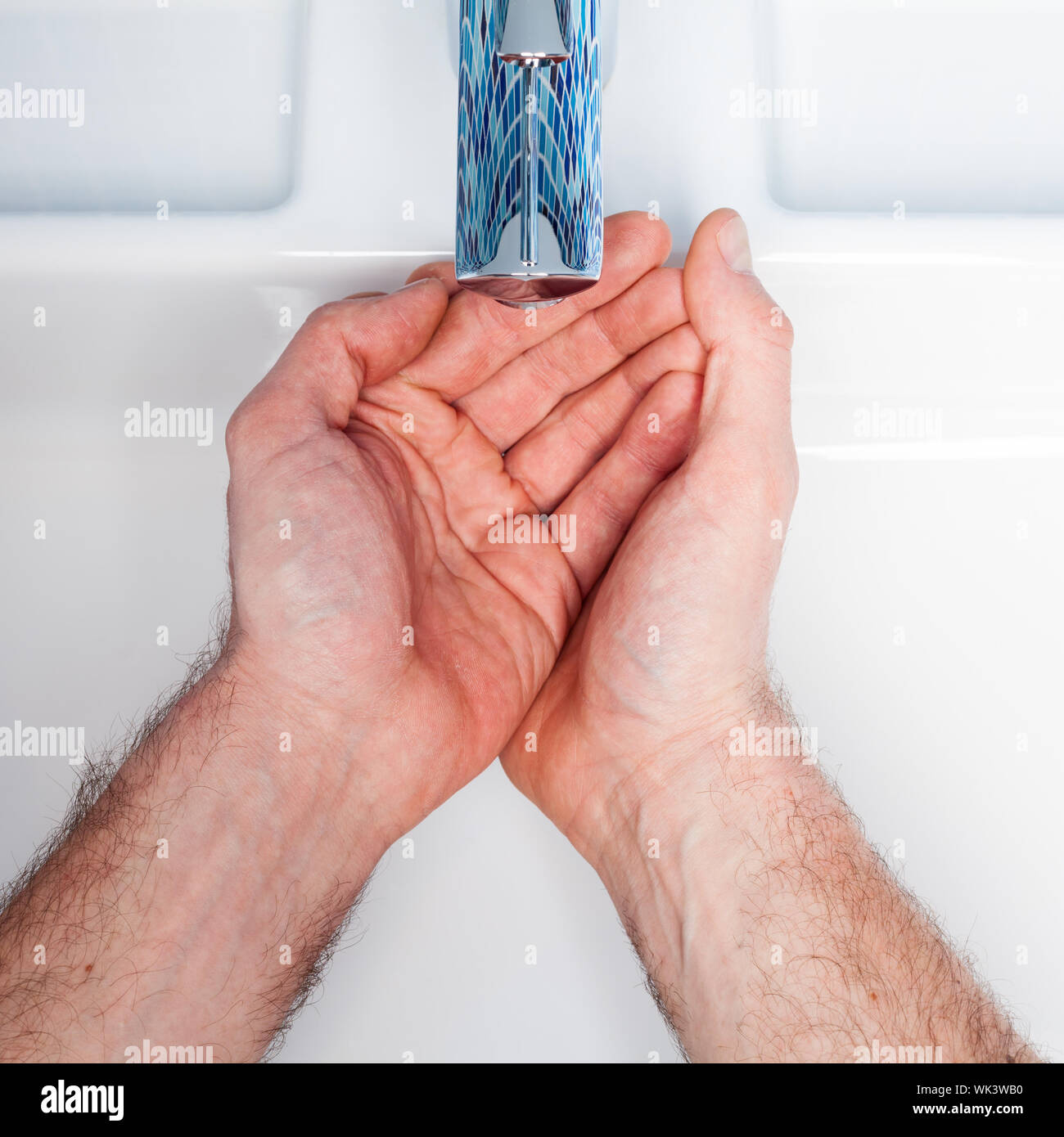 Man waiting to get water from bathroom sink Stock Photo - Alamy