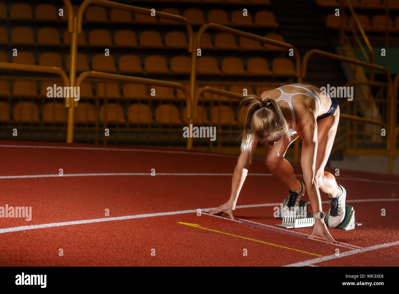 Female runner athlete starting running sprint race on the lane Stock ...