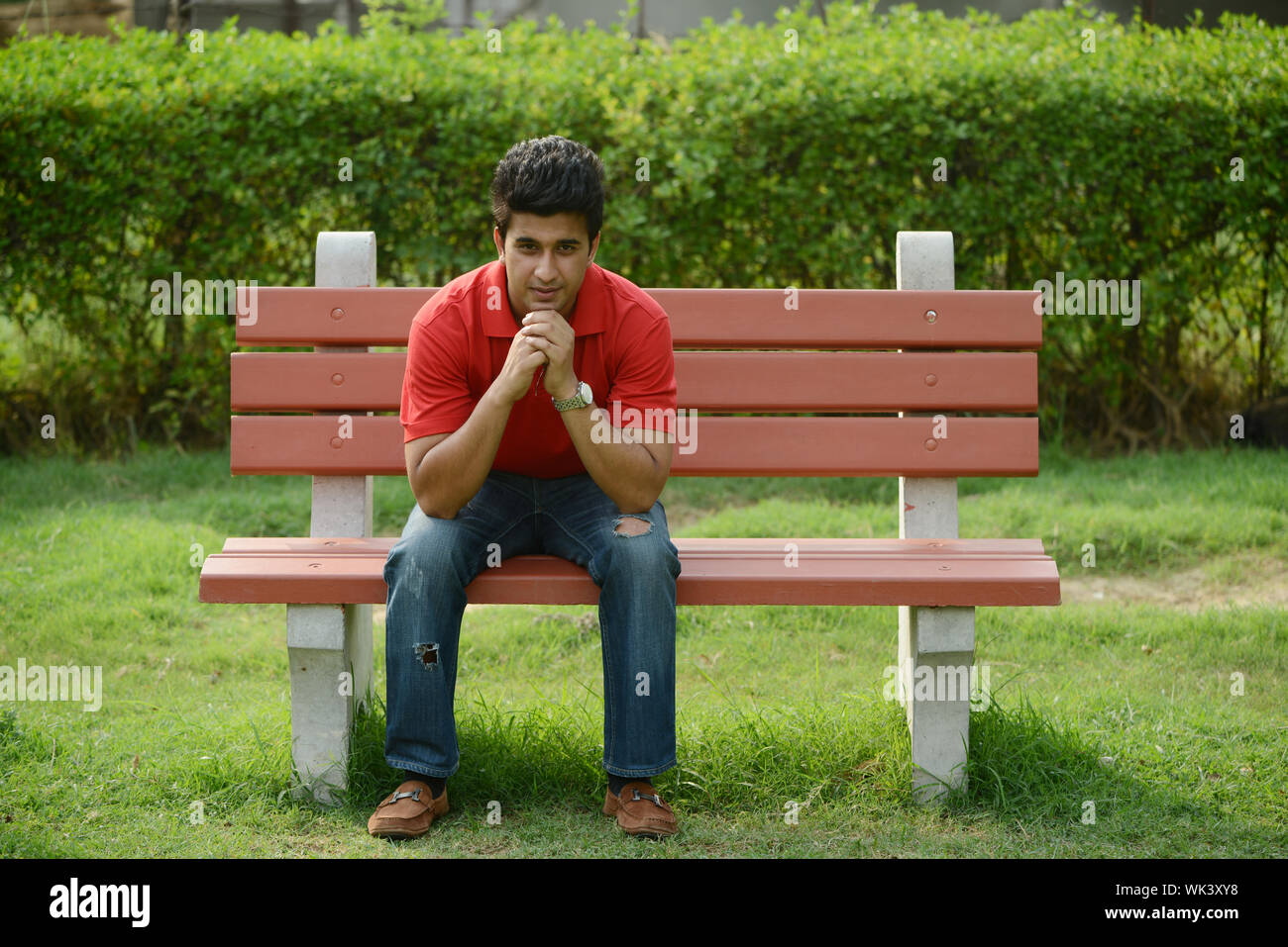 Young indian man sitting bench hi-res stock photography and images - Alamy