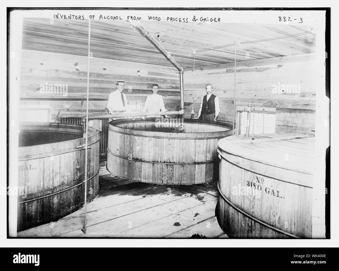 Inventors of alcohol from wood process and gauger in front of large ...