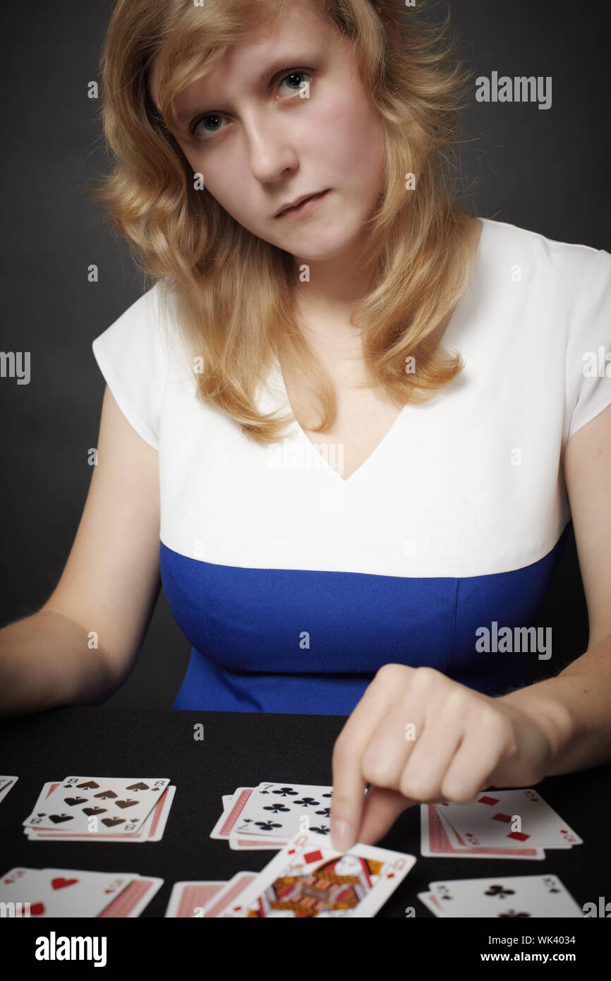 Woman playing solitaire card game hi-res stock photography and images ...