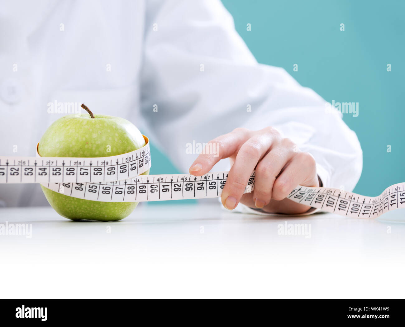 Doctor holding measuring tape hi-res stock photography and images - Alamy