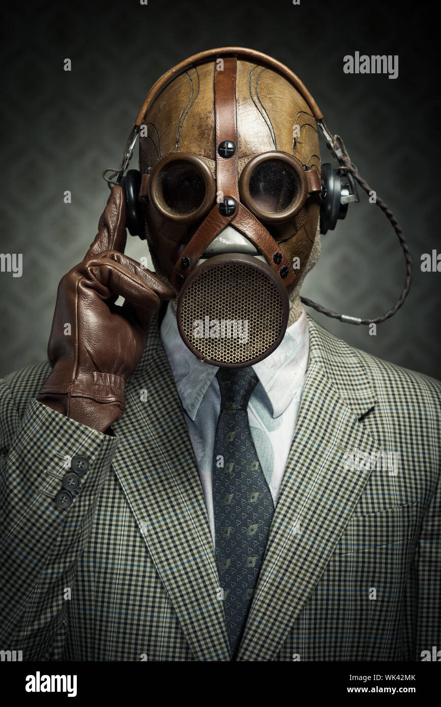 Man wearing vintage gas mask and headphones listening to music Stock ...