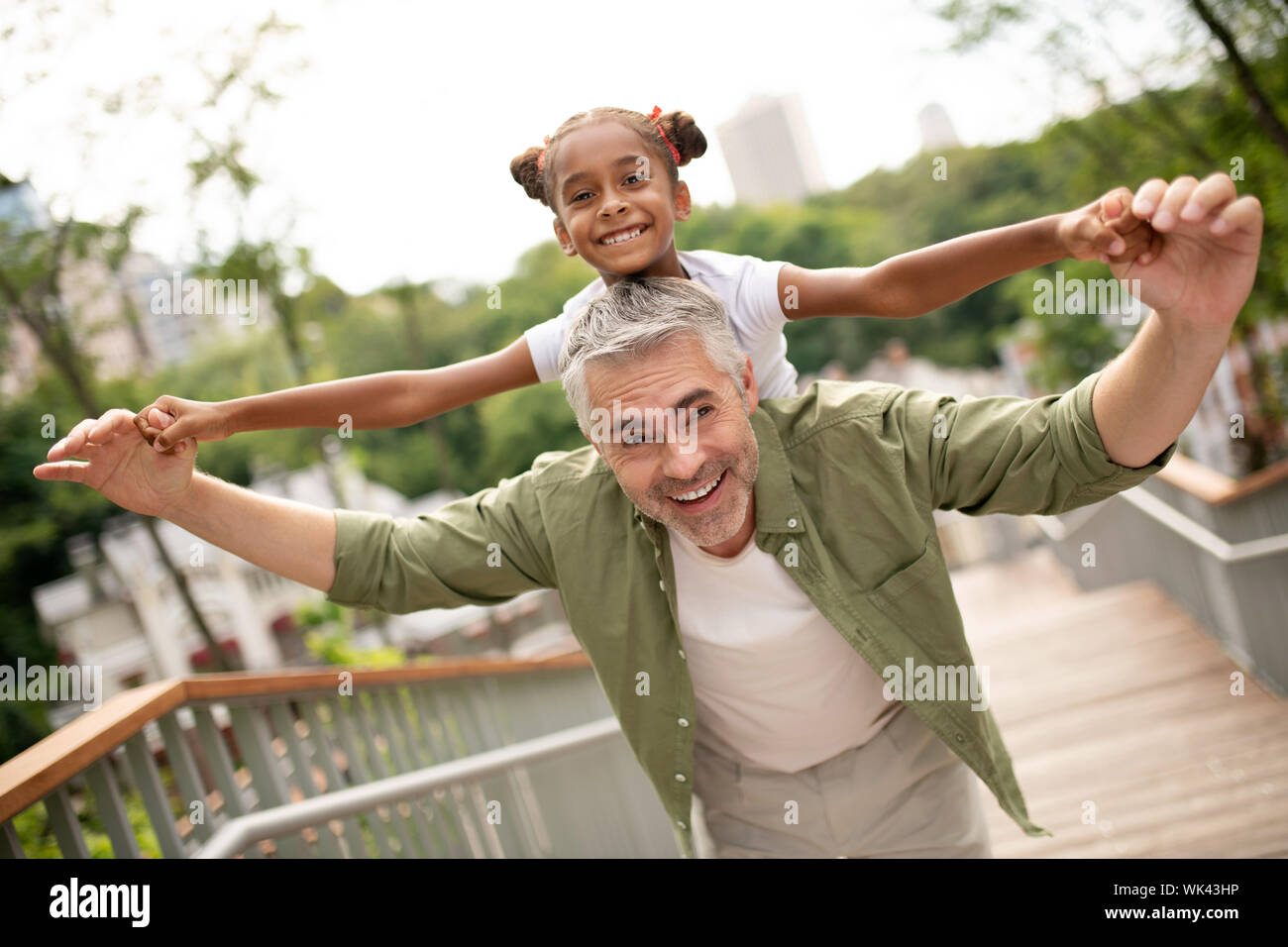 Beaming beautiful daughter feeling happy with daddy Stock Photo - Alamy