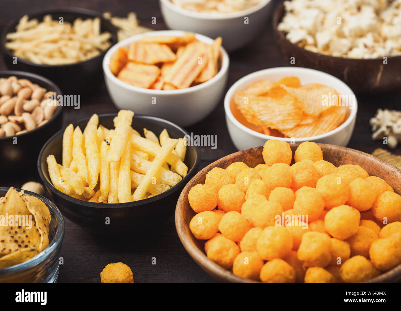 All classic potato snacks with peanuts, popcorn and onion rings and ...